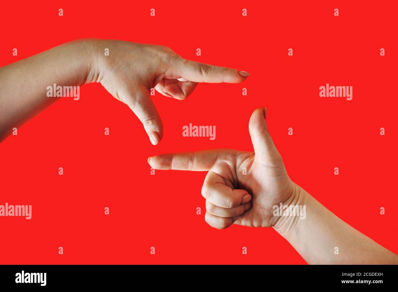 Female hands making frame on red background. Women's palms in the shape ...