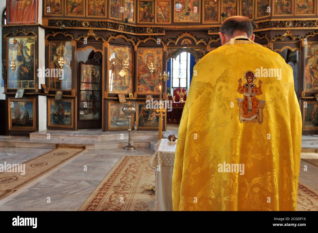 The priest standing in front of icinostasis in an Orthodox Church Stock ...