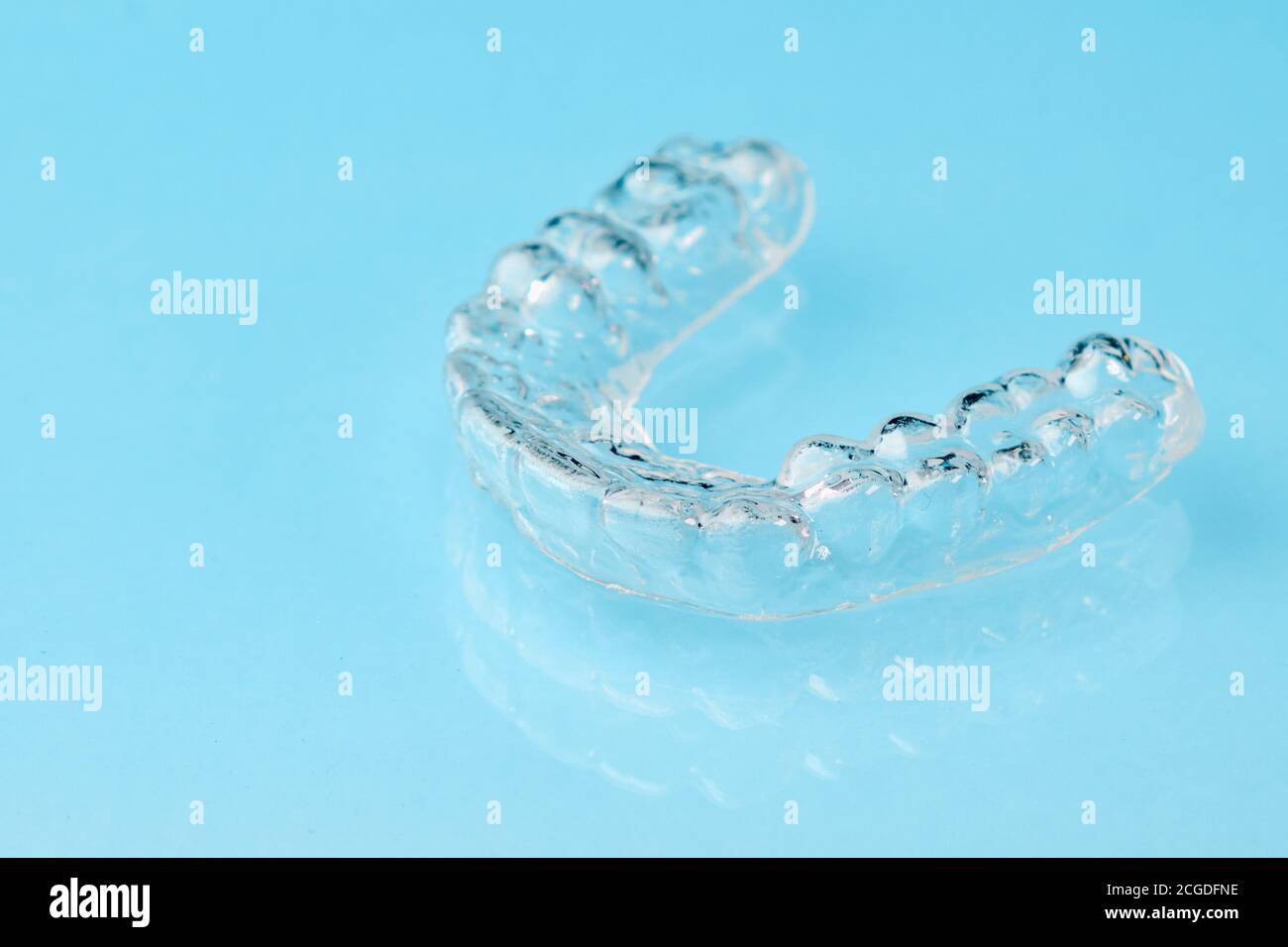 Close up invisible aligners on the blue background with copy space ...
