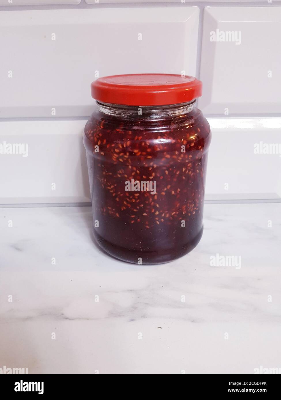 jar of raspberry jam on white background Stock Photo - Alamy