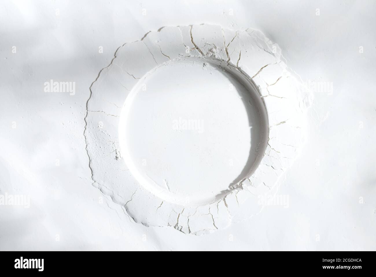 Decorative round frame from white powder, flour or grinded chalk on a ...