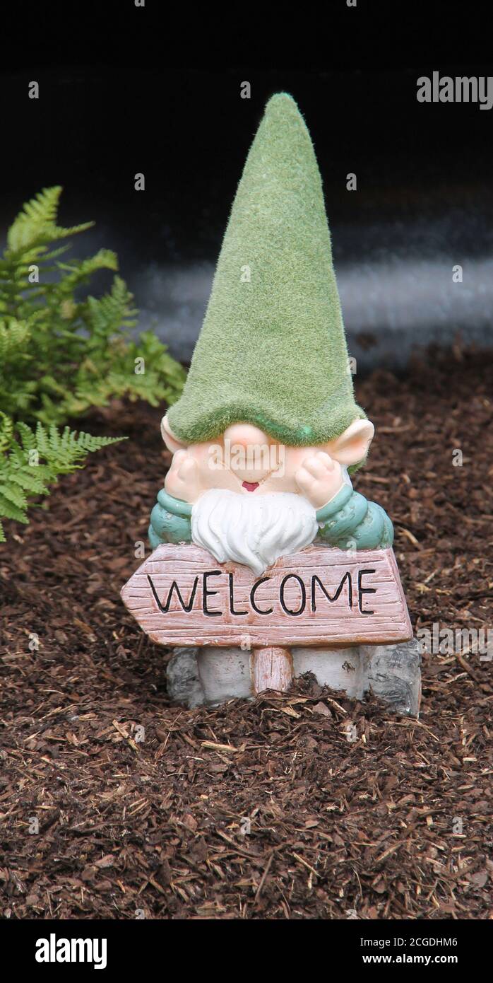 A Welcome Sign and Cute Garden Gnome Ornament Stock Photo - Alamy