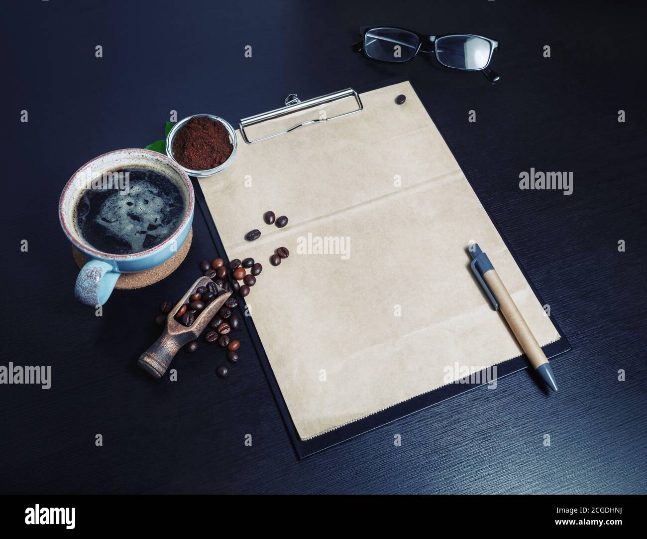 Clipboard with blank kraft paper, coffee cup, coffee beans, glasses and ...