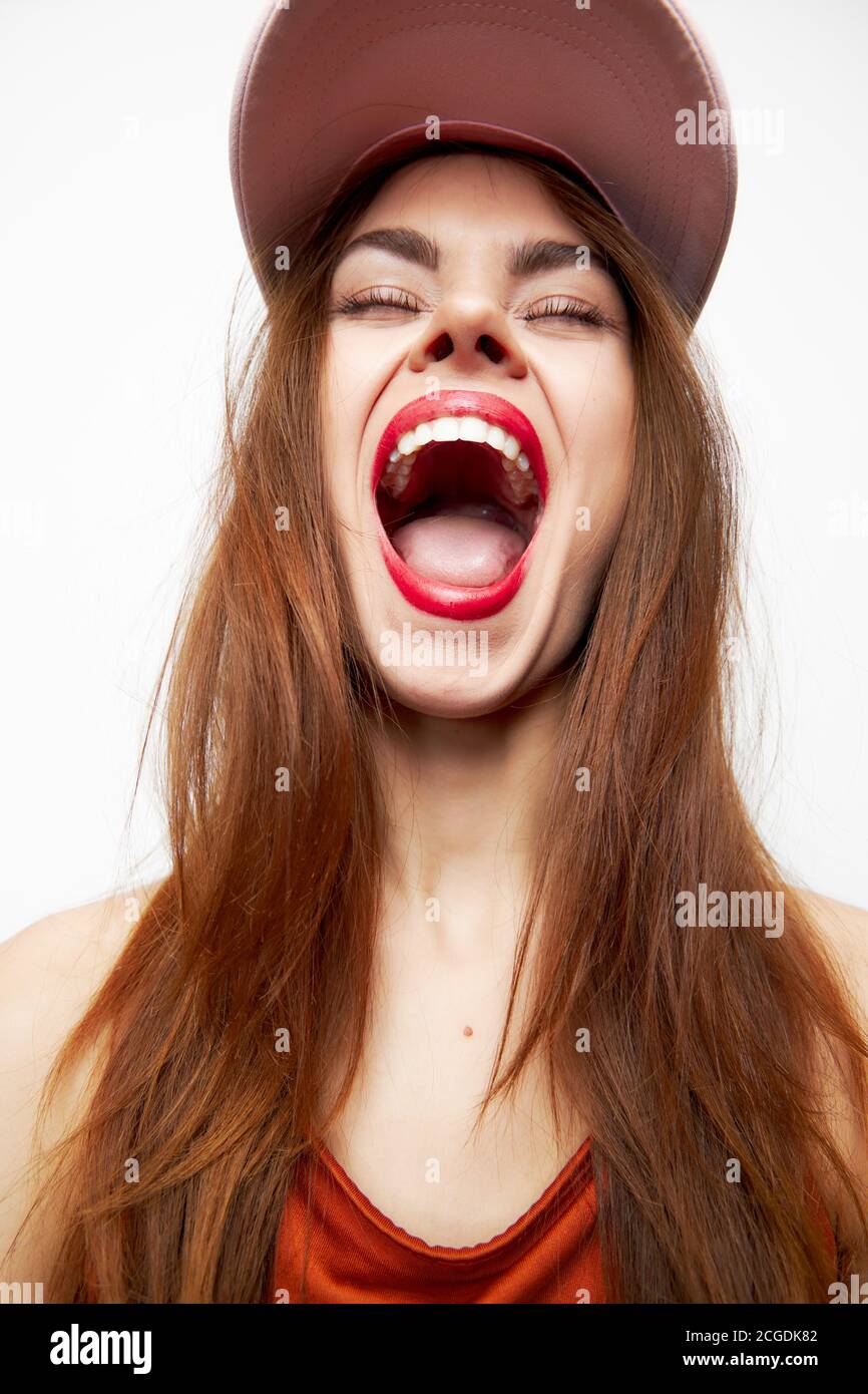 Emotional woman in a cap Eyes closed, mouth wide open Stock Photo - Alamy