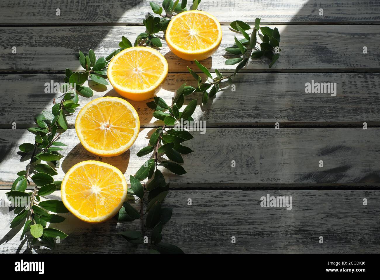 half juicy oranges nicely arranged on a white shabby chic wooden table ...