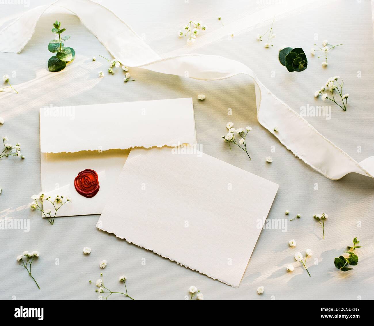 Warm cream colored envelope with red ink stamp with lace and flowers ...