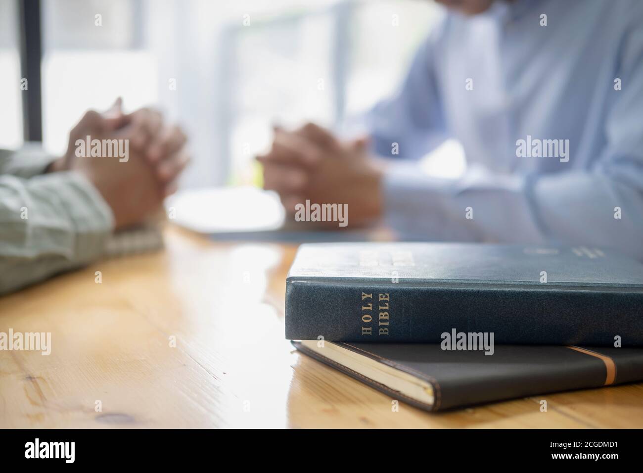 Two christian people are praying together over holy bible Stock Photo ...