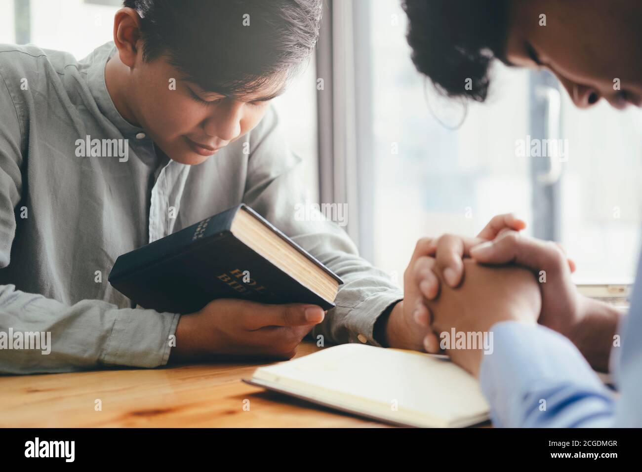 Two people praying together hi-res stock photography and images - Alamy