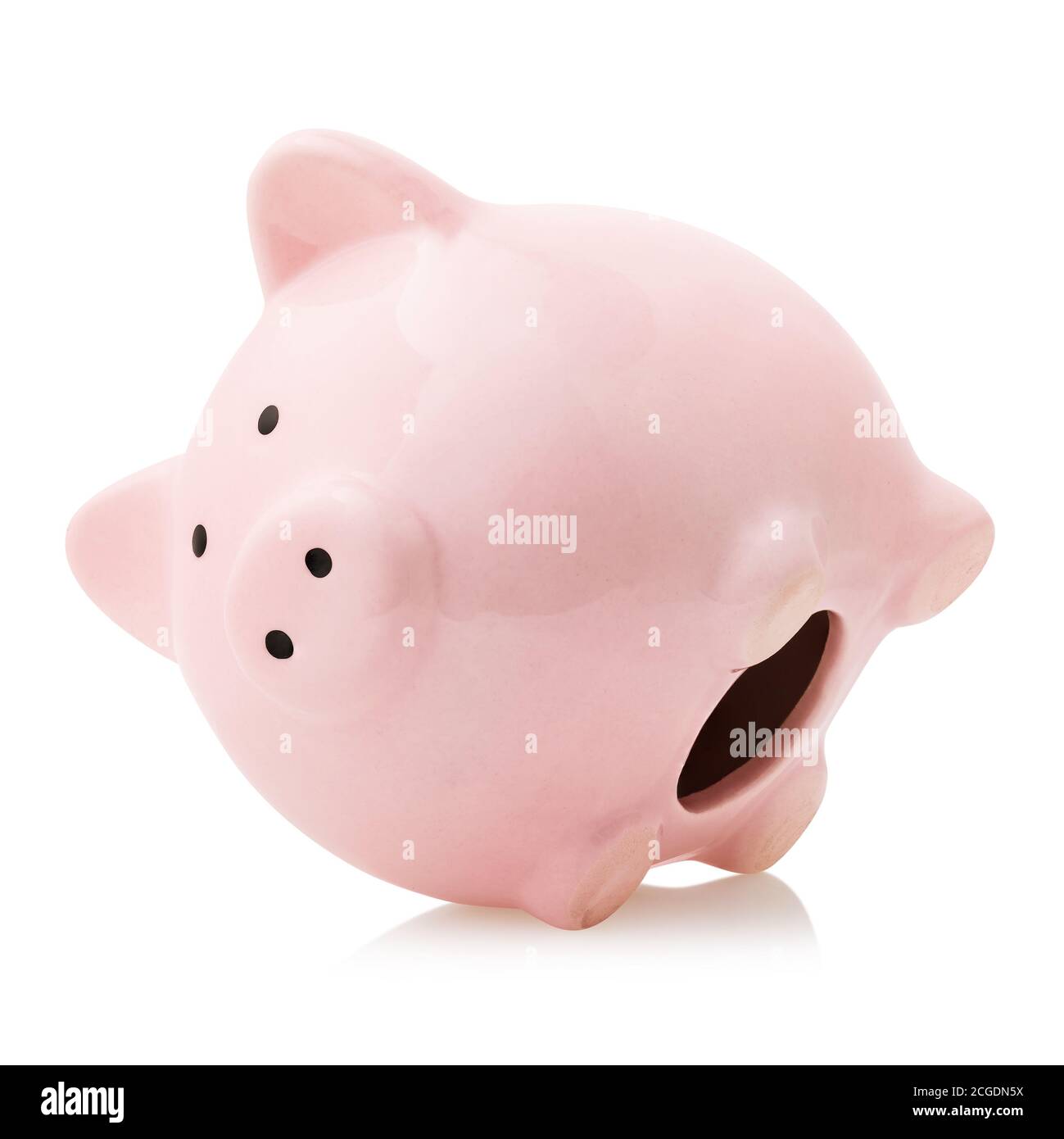 A pink piggy bank lies on its side, isolated on a white background ...