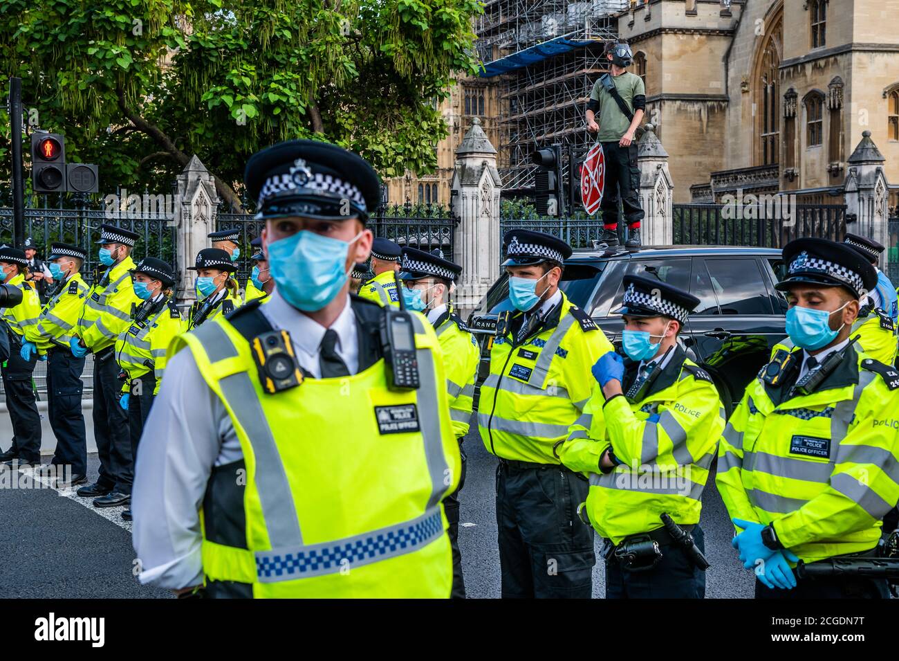 London, UK. 10th Sep, 2020. A man defies the police by standing on one ...