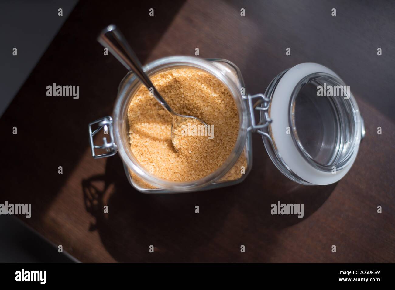 Transparent glass jar with brown sugar cane on a black background Stock ...
