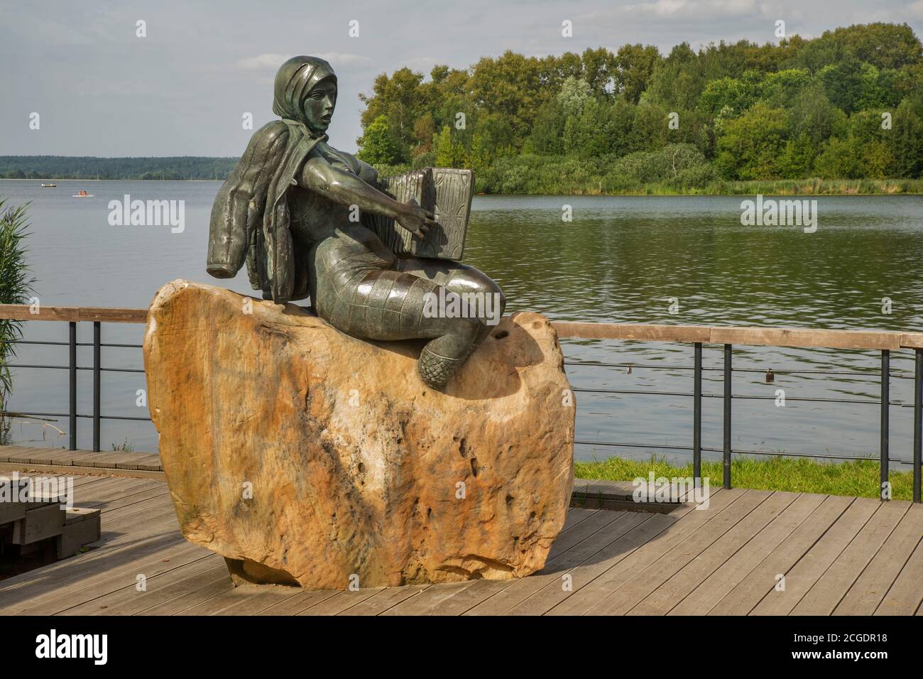 Sculpture of mermaid with button accordion on embankment of Senezh lake ...