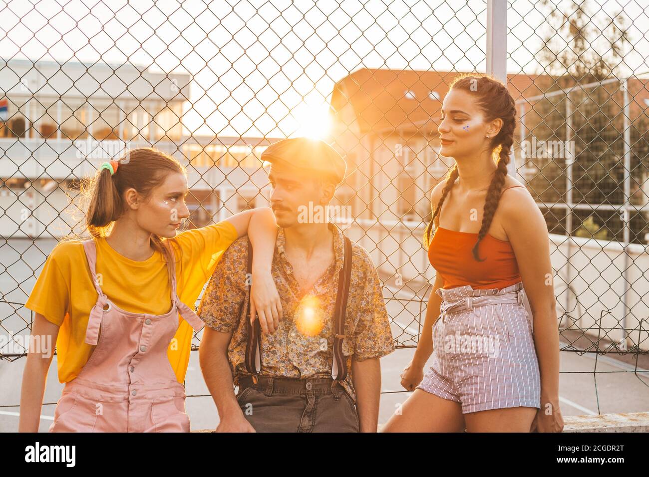 Two girls and one guy have sit outside. Afternoon light Stock Photo - Alamy