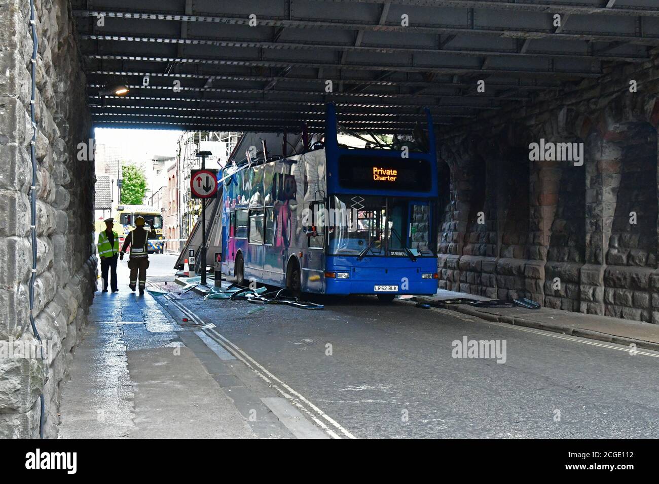 Upper deck of bus jammed under bridge hi-res stock photography and ...
