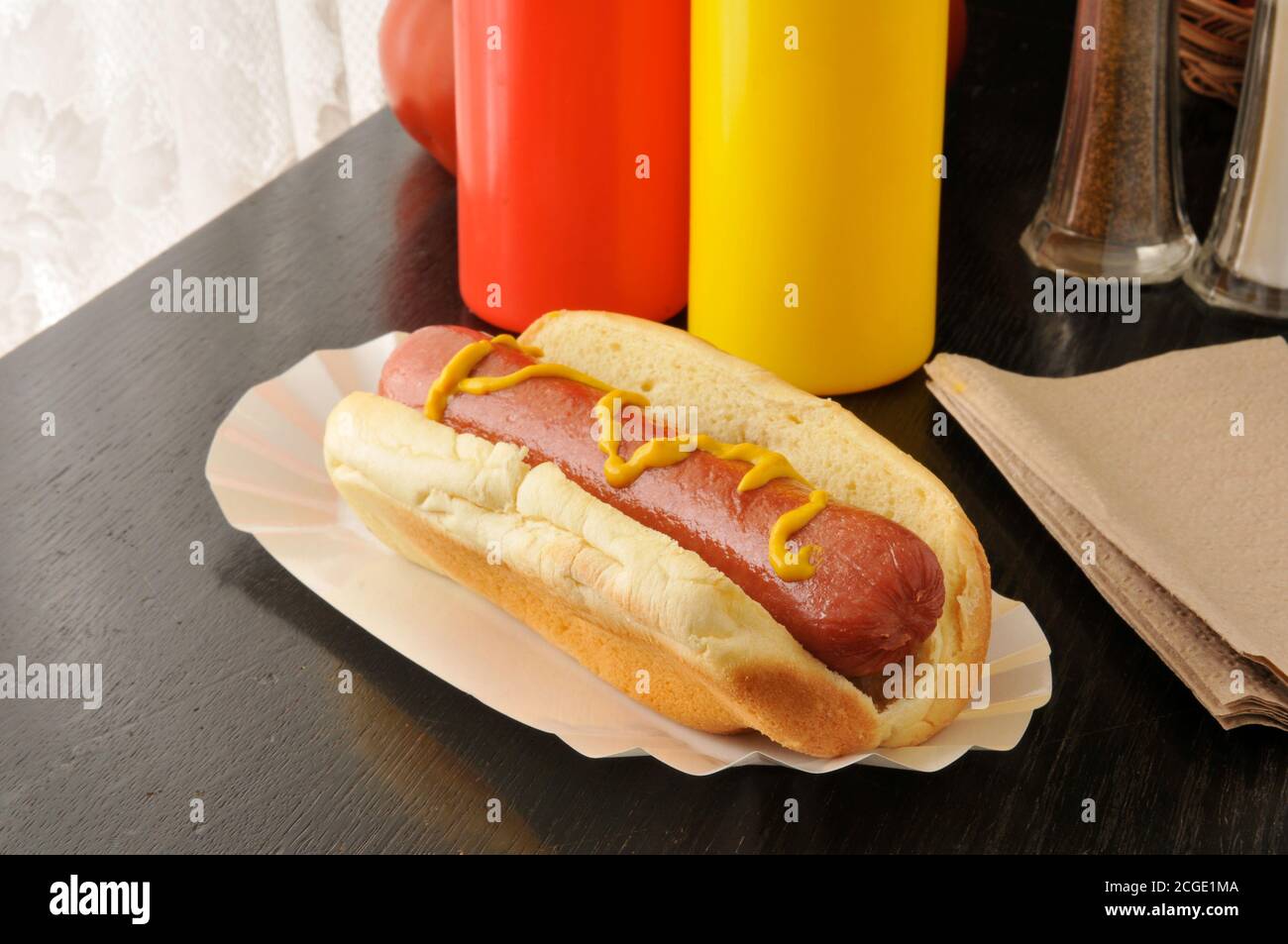 Hot dog with mustard on a table by the window Stock Photo - Alamy