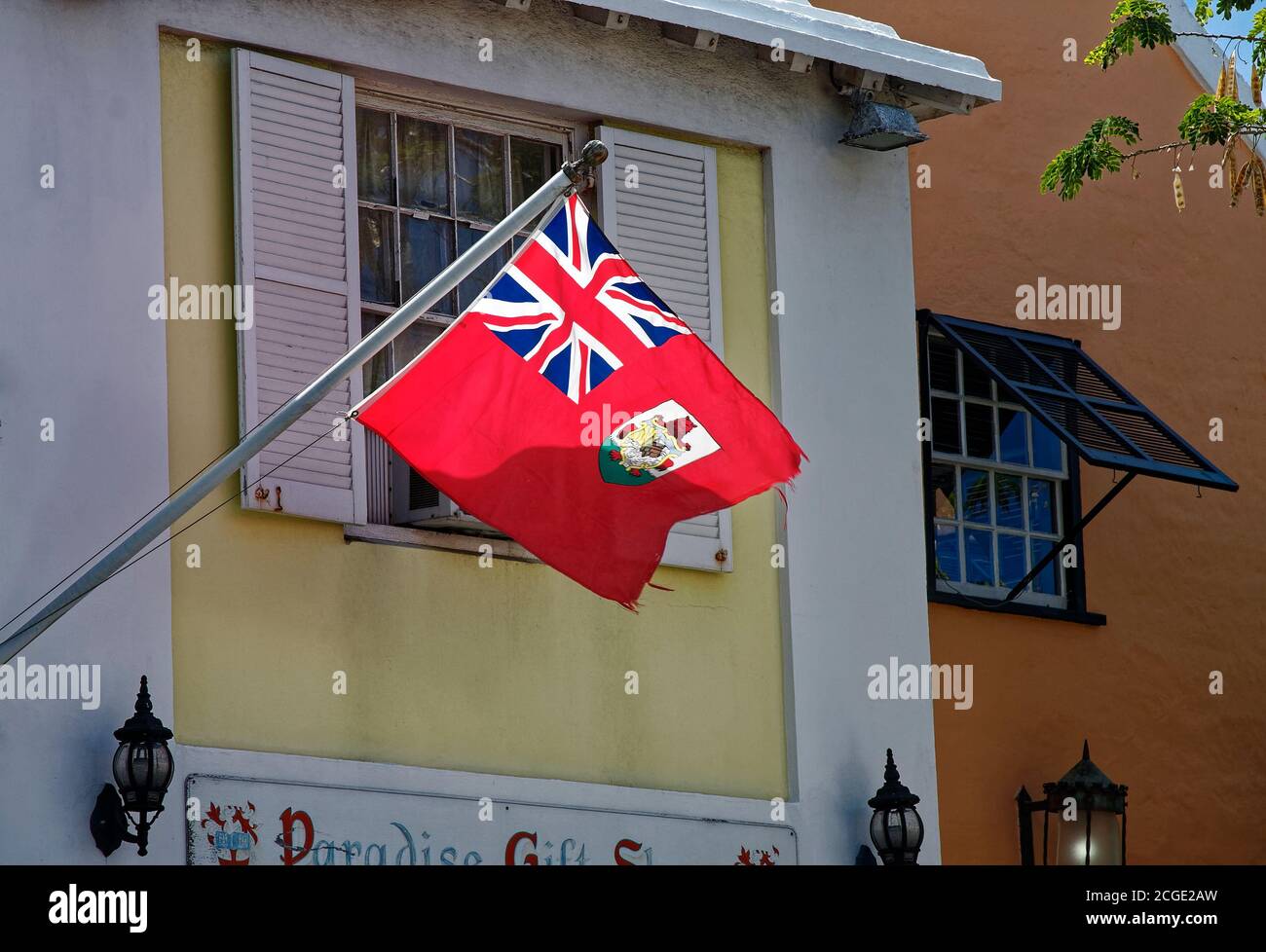 Bermuda flag flying, red background, British Union Jack, oval crest ...