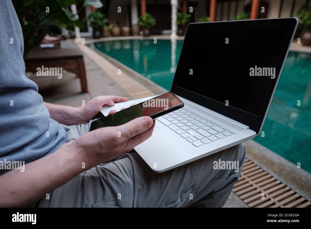 Using computer in swimming pool hi-res stock photography and images - Alamy