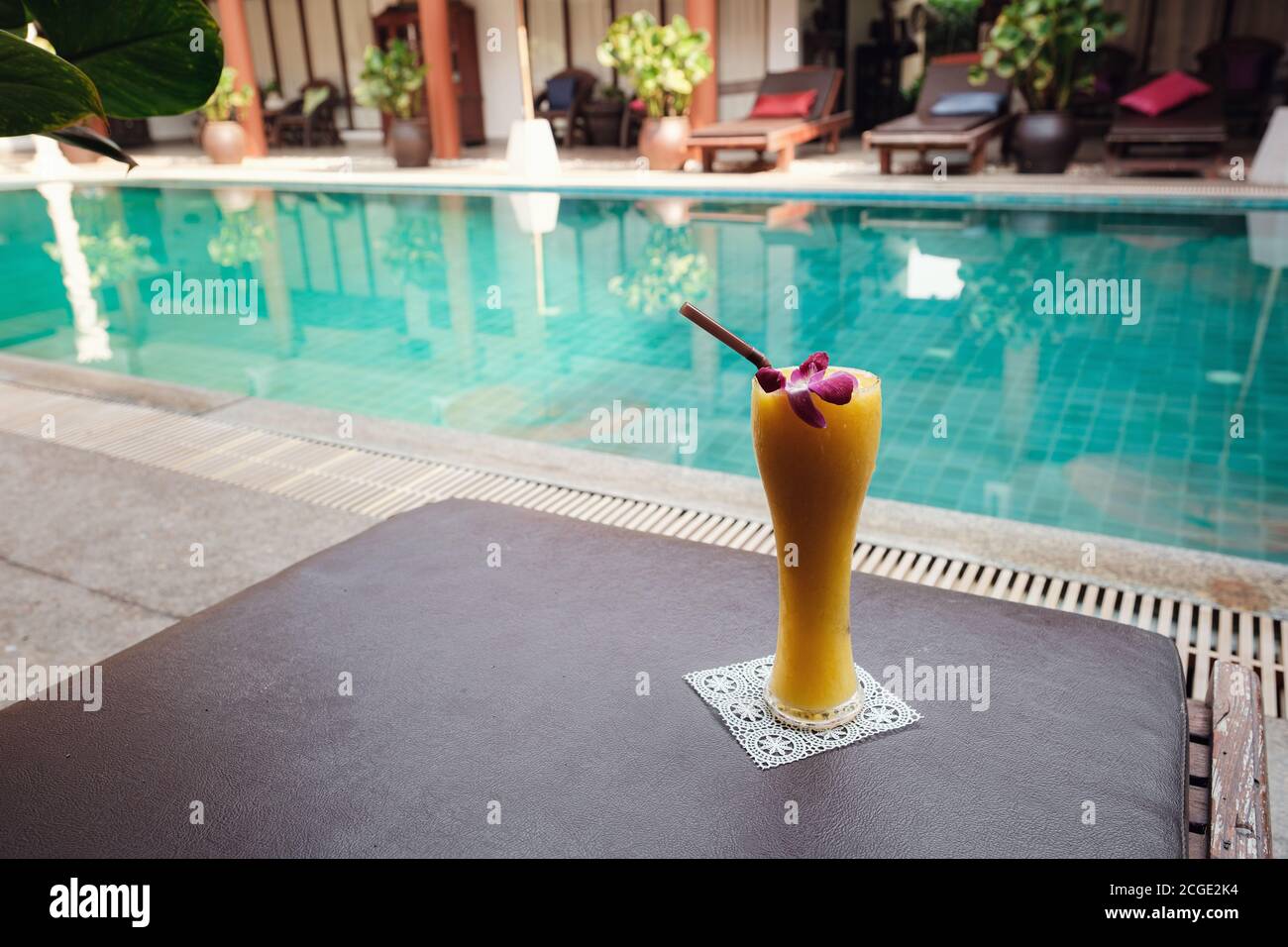 fresh tropical smoothie or mango juice in a tall glass on the ...