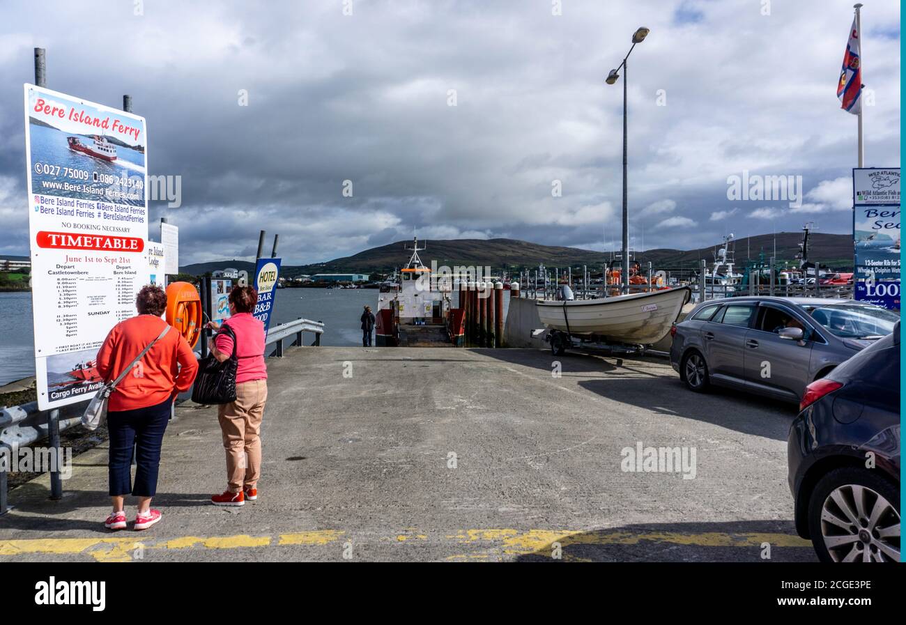 People inspecting the timetable for the Bere Island Ferry in ...