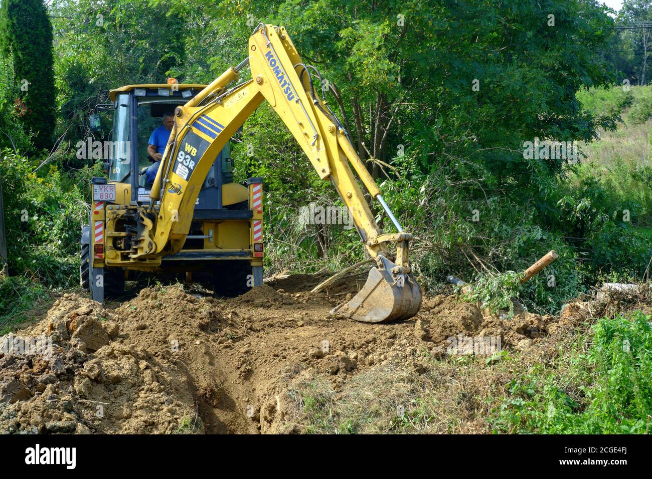heavy plant digger digging trench in preparation for the laying of new ...