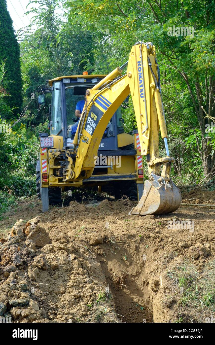 heavy plant digger digging trench in preparation for the laying of new ...