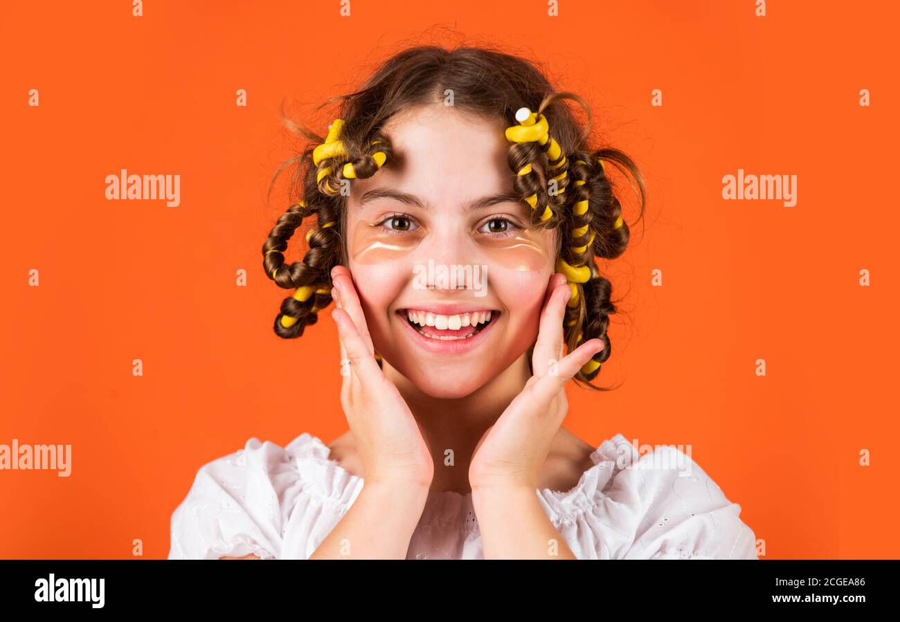 Styling tips. Teen hobbies. Small girl Curling Hair Using Curlers ...