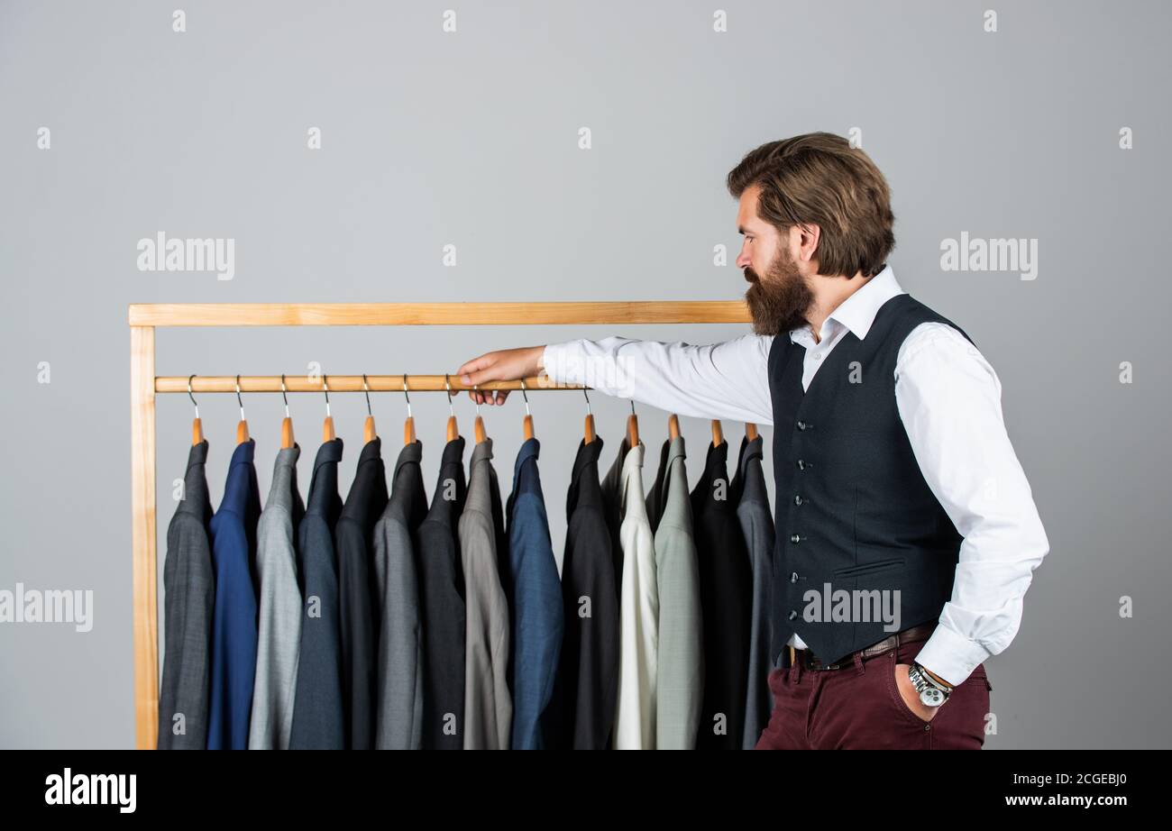 Man picking suit from personal wardrobe, tailored blazer concept Stock ...