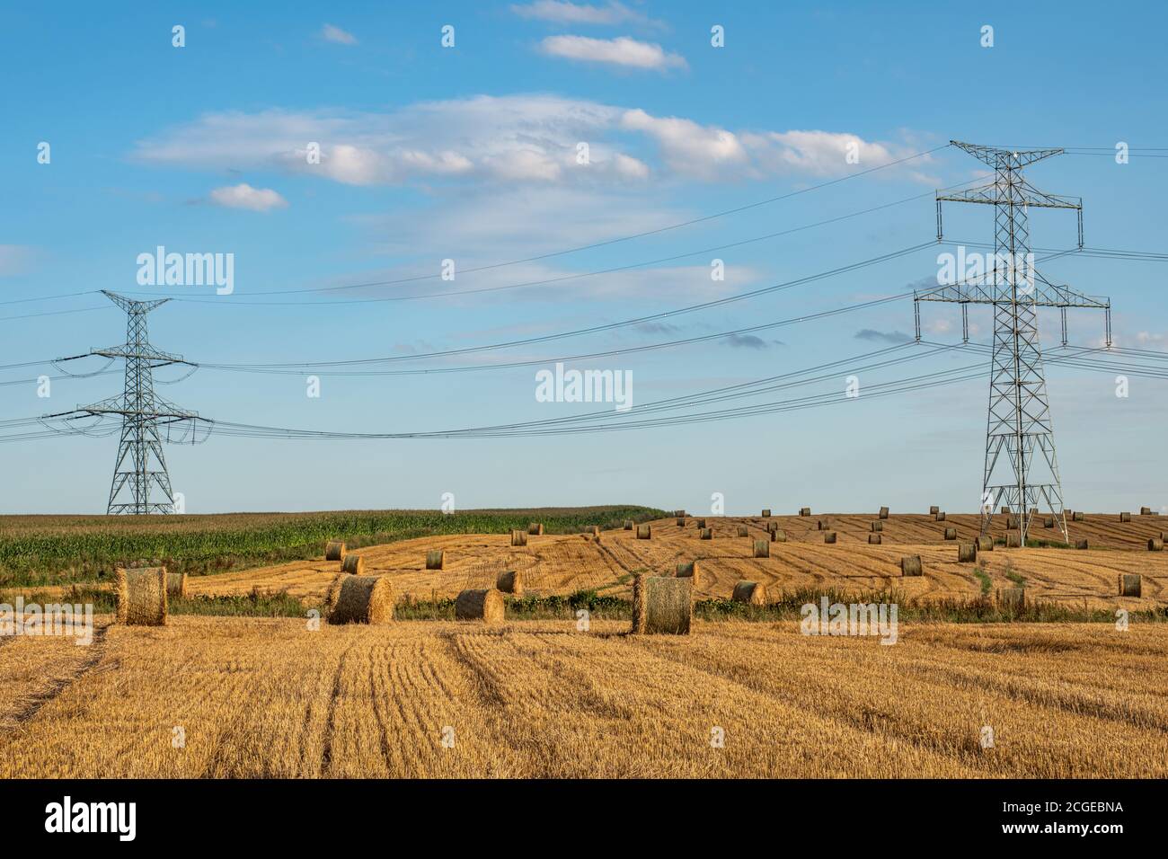 Straw bales on the field near high electricity pylons Stock Photo - Alamy