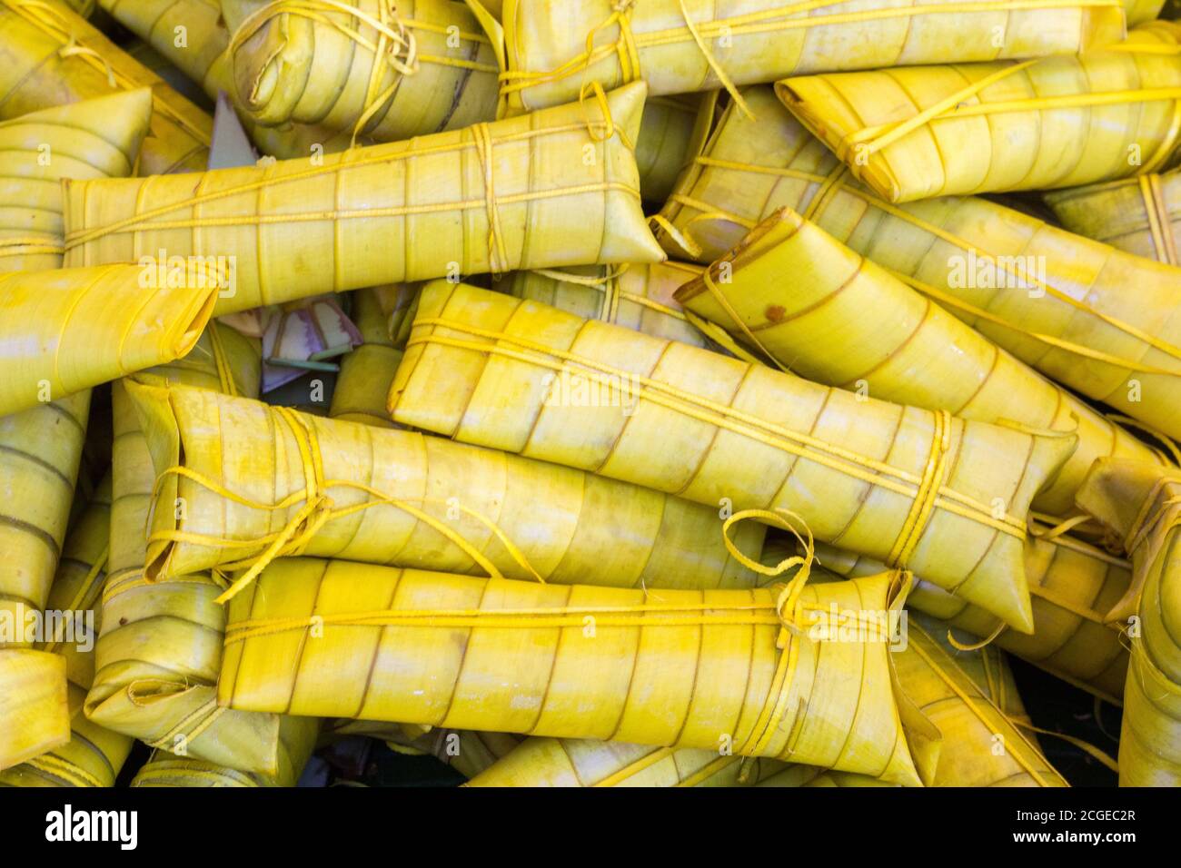 Traditional Filipino rice cakes called suman, wrapped in young coconut ...