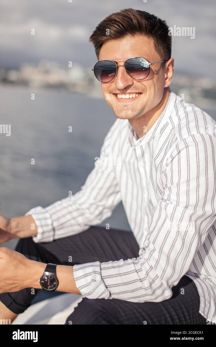 sailing, tourism, travel, business and people concept - handsome man on ...