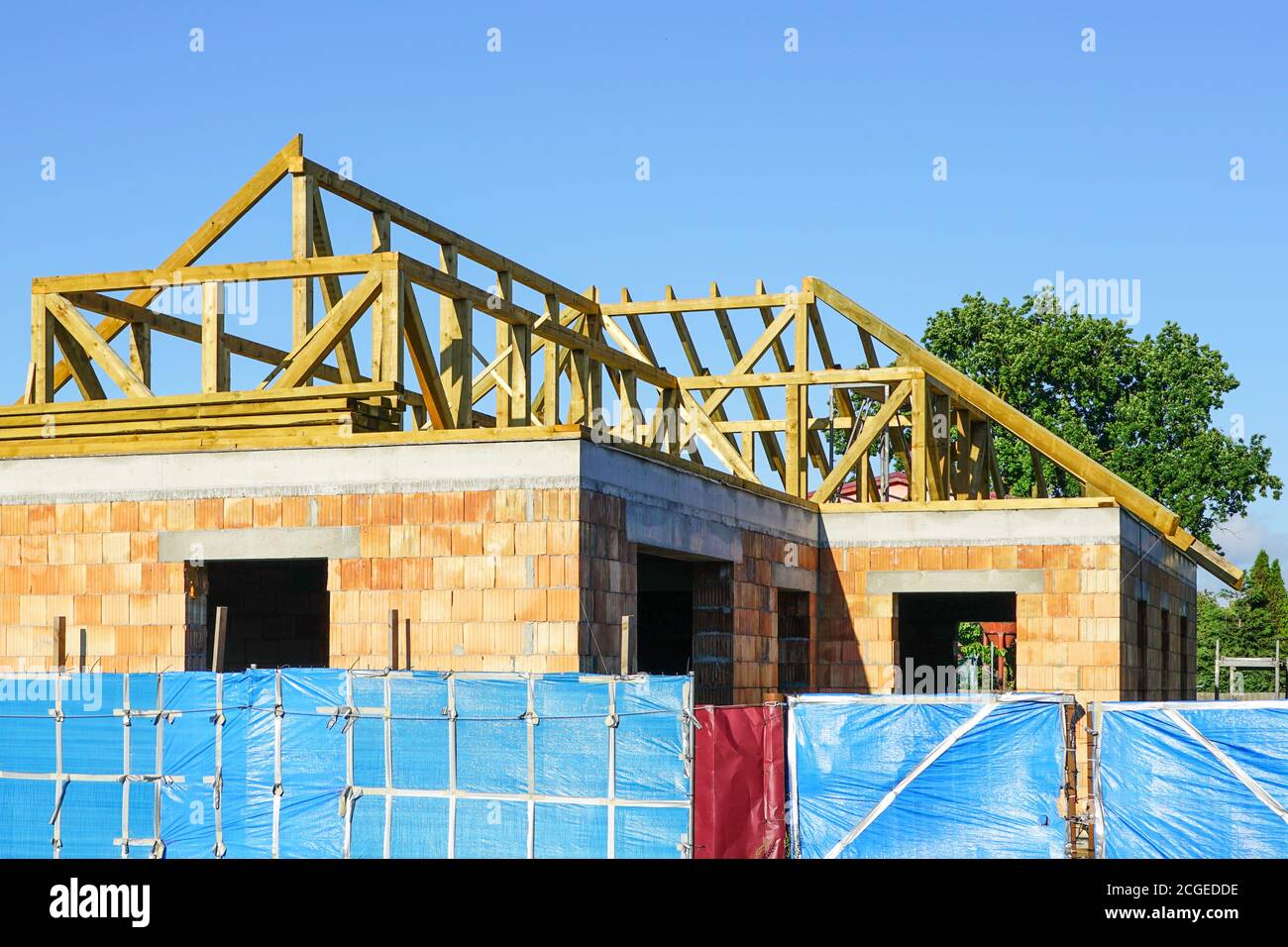 construction of a new residential house roof structure on a blue sky ...