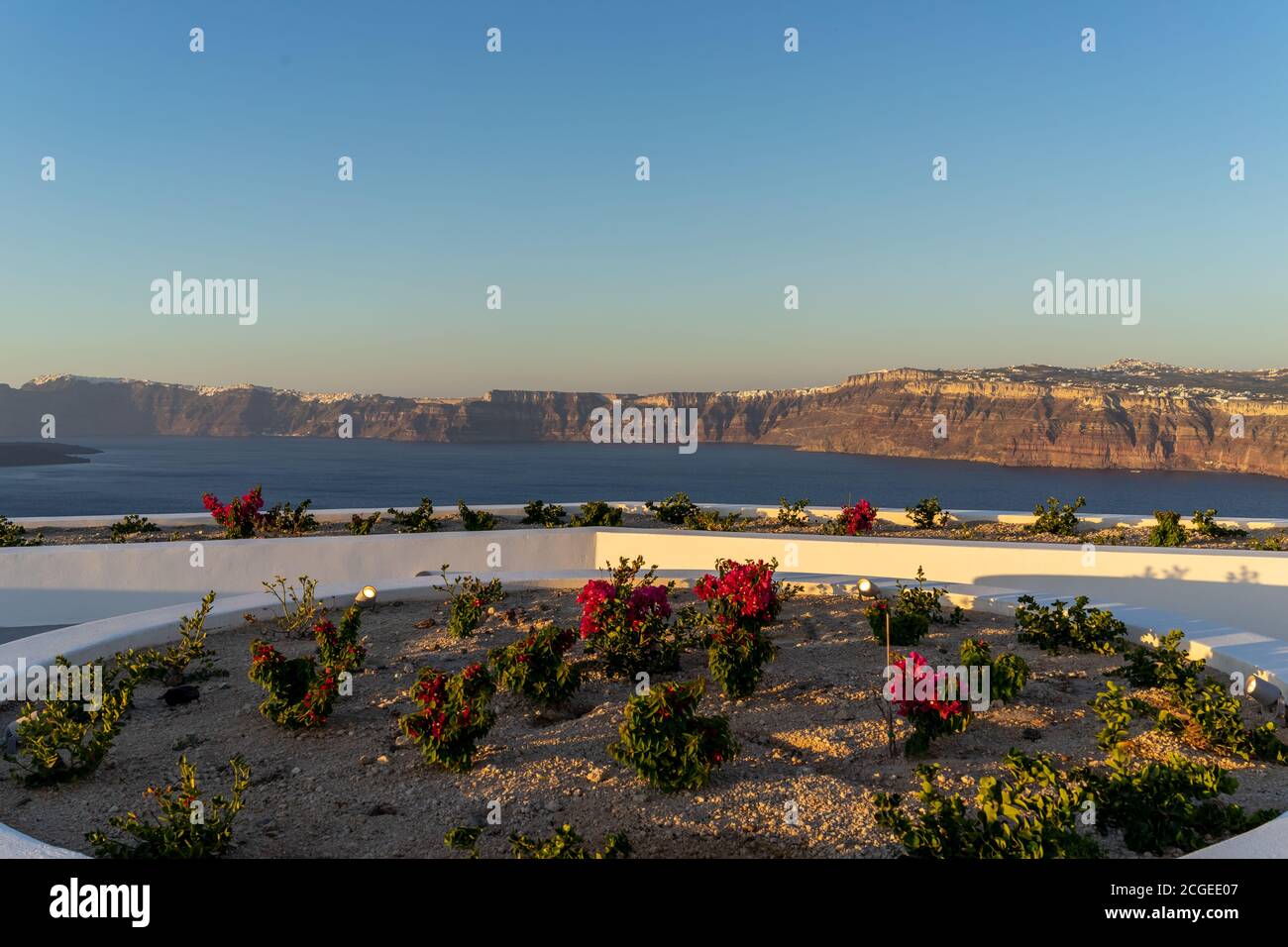 sunset over the sea. akrotiri, santorini, Greece. pink bougainvillea on ...