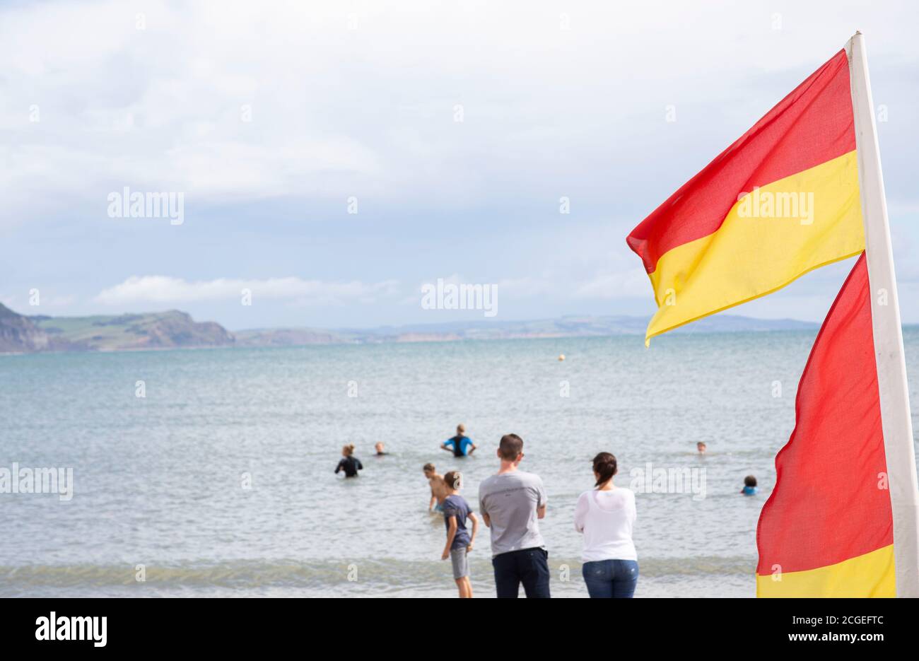 Swim safety flags at Lyme Regis, Dorset Stock Photo - Alamy