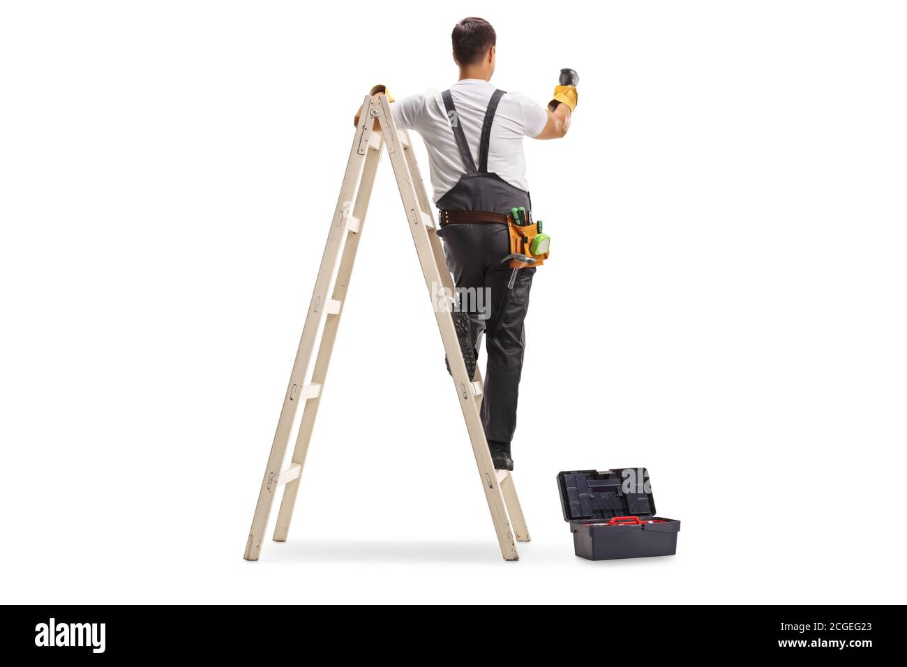 Full length rear view shot of a repairman on a ladder drilling with a machine into a wall ...