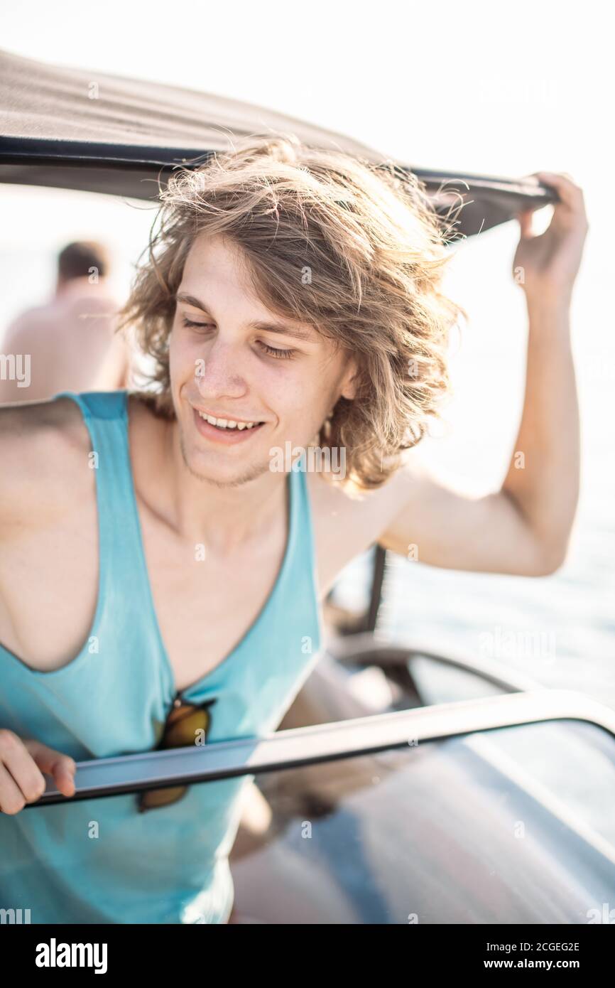 sailing, youth, vacation and tourism concept - happy young skiper man ...