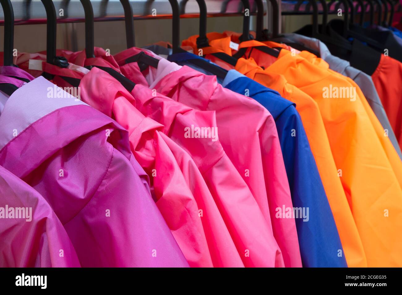 Colorful t-jacket on hangers, close up view Stock Photo - Alamy