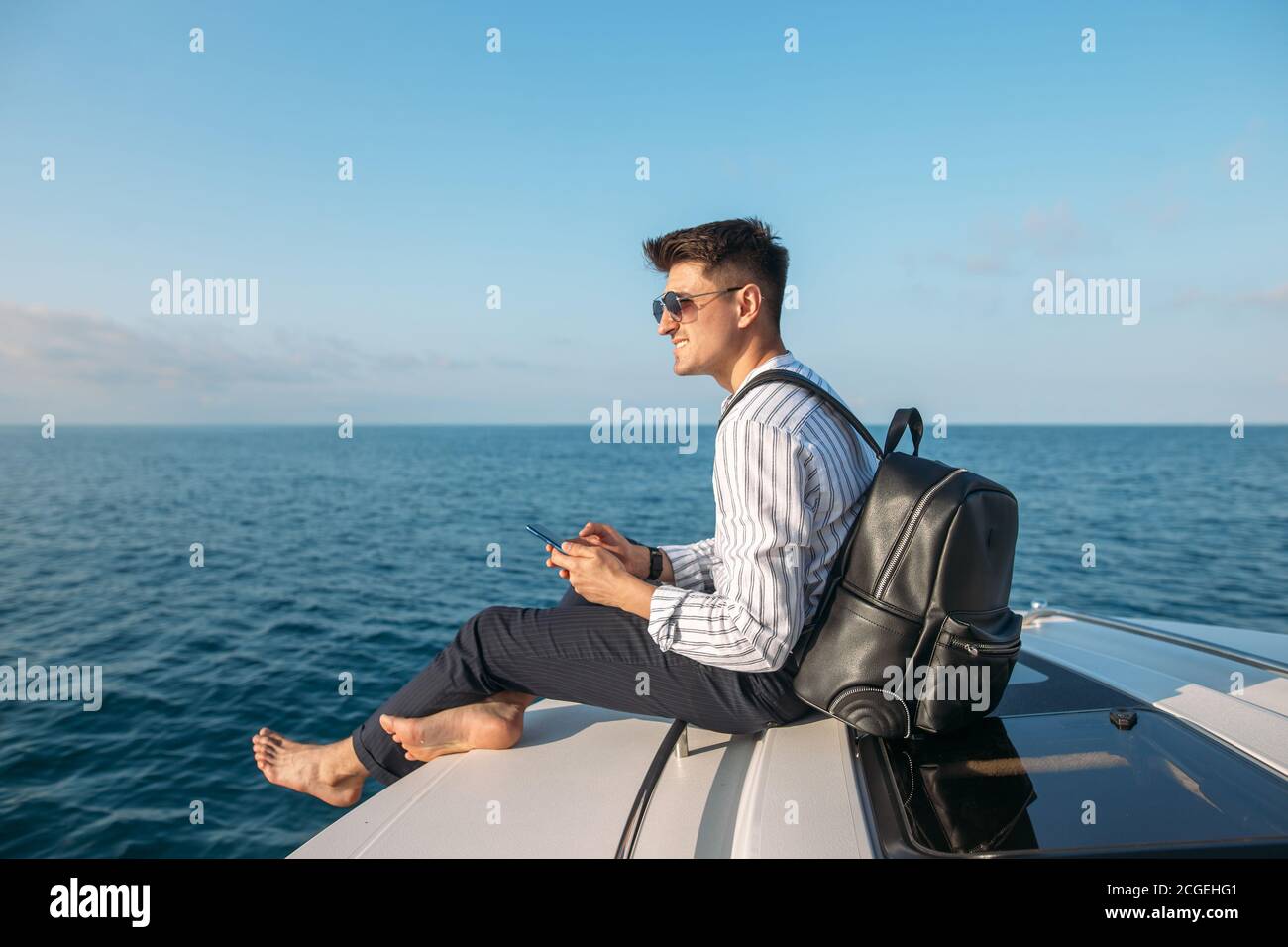 sailing, tourism, travel, business and people concept - handsome man on ...