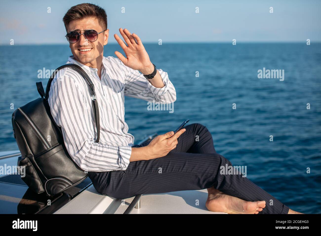 sailing, tourism, travel, business and people concept - handsome man on ...