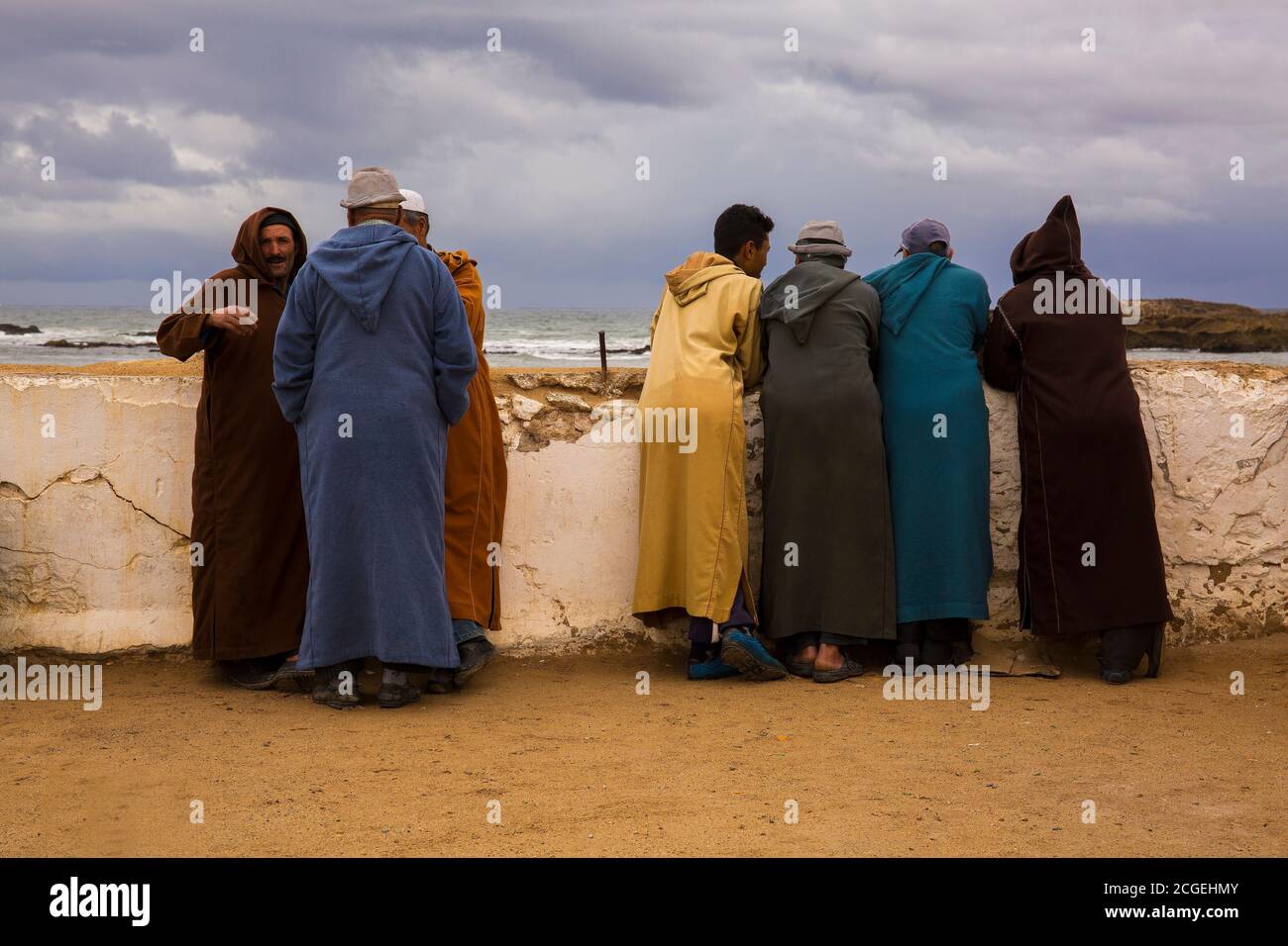 A group of men dressed in colorful djellabas - traditional dress worn ...