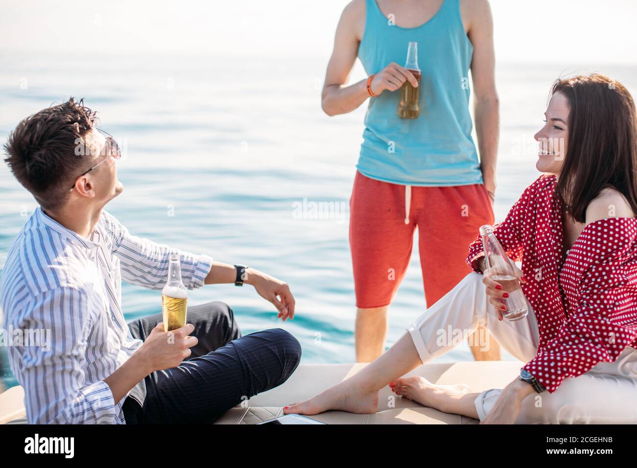 friends drinking beers in boat party. Group of people partying on yacht ...