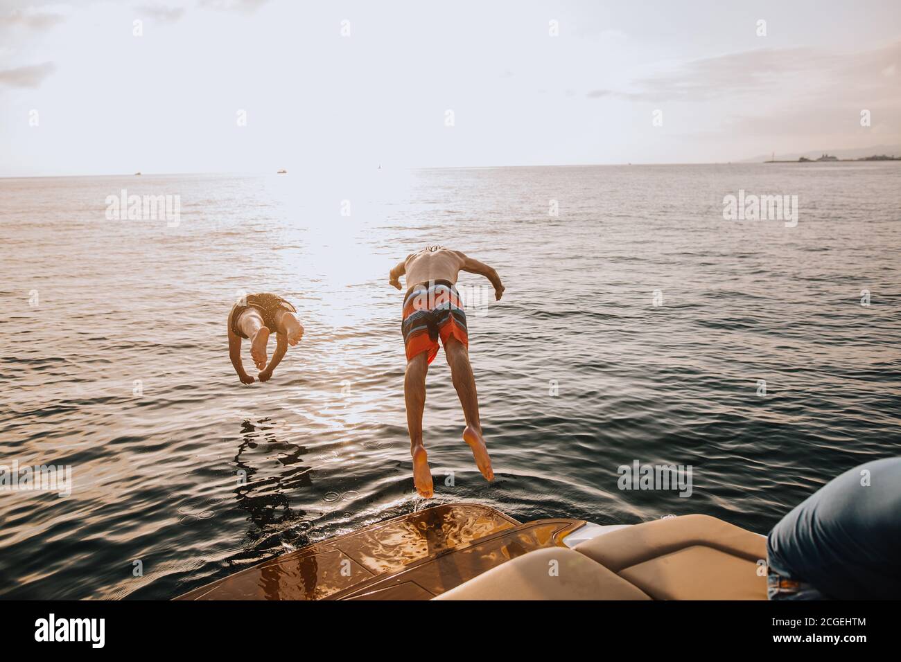 Man jumping into sea from boat hi-res stock photography and images - Alamy