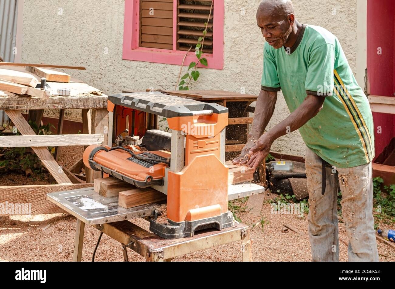 .Man Guiding Wood Through Planer Stock Photo - Alamy