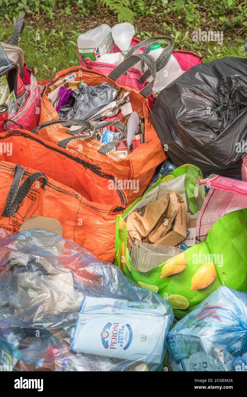 Pile of weekly domestic rubbish outside rural house awaiting refuse ...