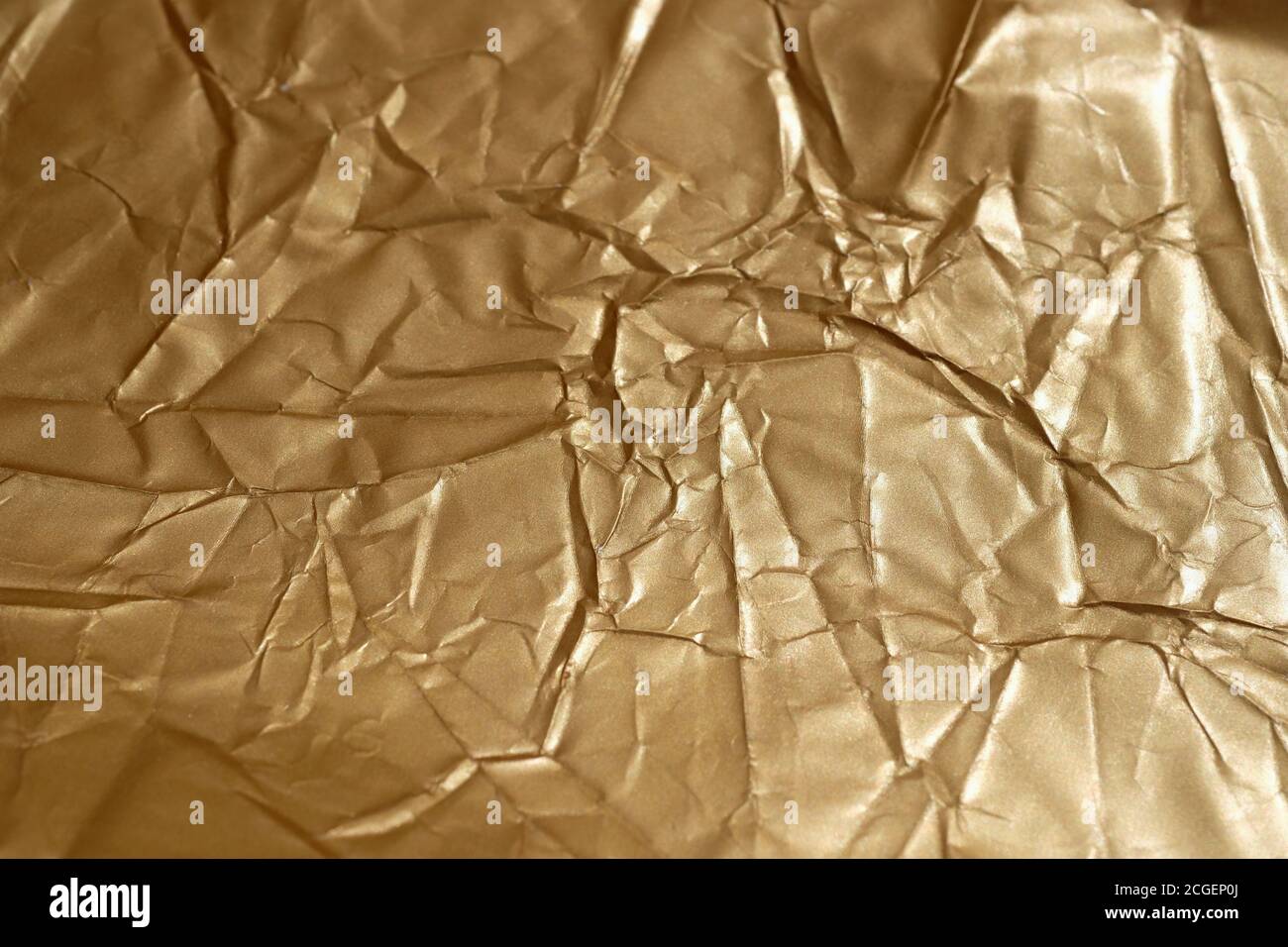 Crumpled gold-colored paper. Background golden from paper top view ... Crumpled gold-colored paper. Background golden from paper top view ...