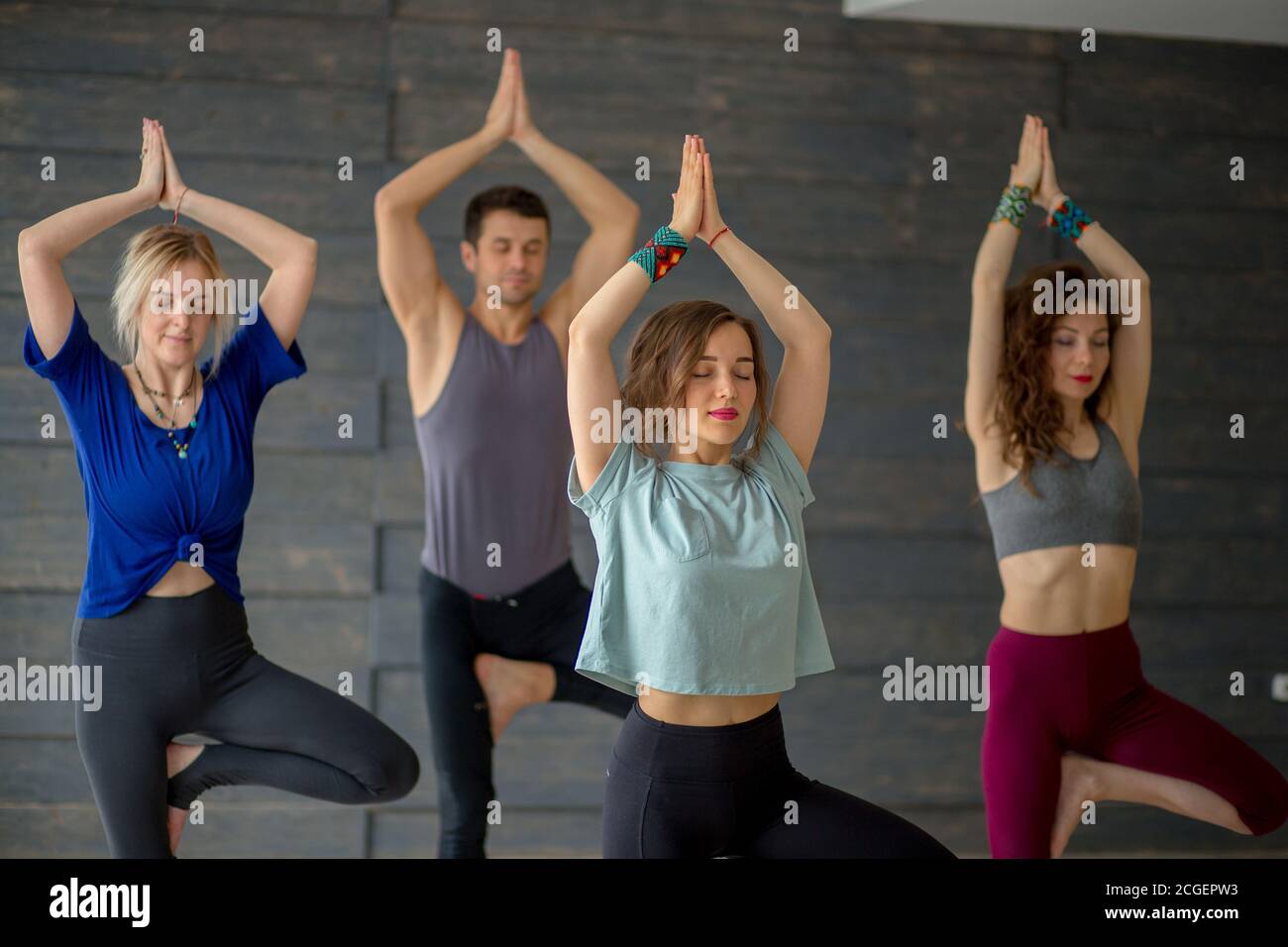 Group of people engaging in his healthy hobby-practicing yoga pose ...