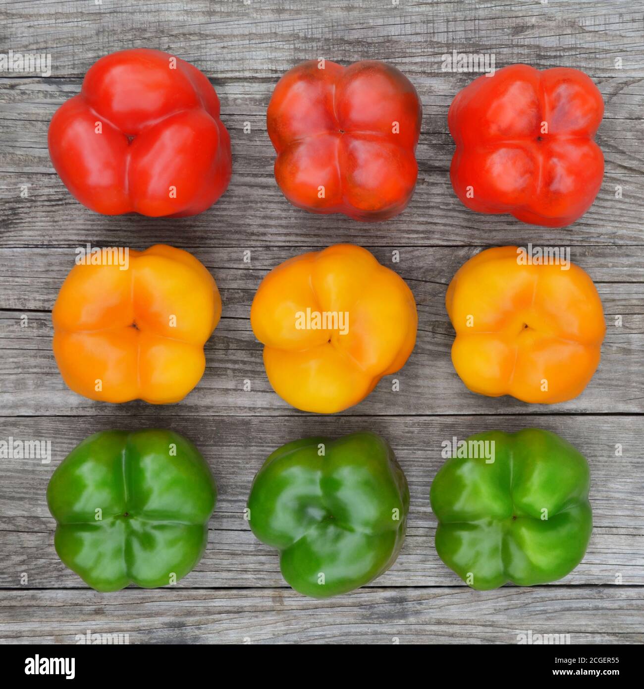 Multi-colored bell peppers on a rustic wooden background. Close-up, top ...