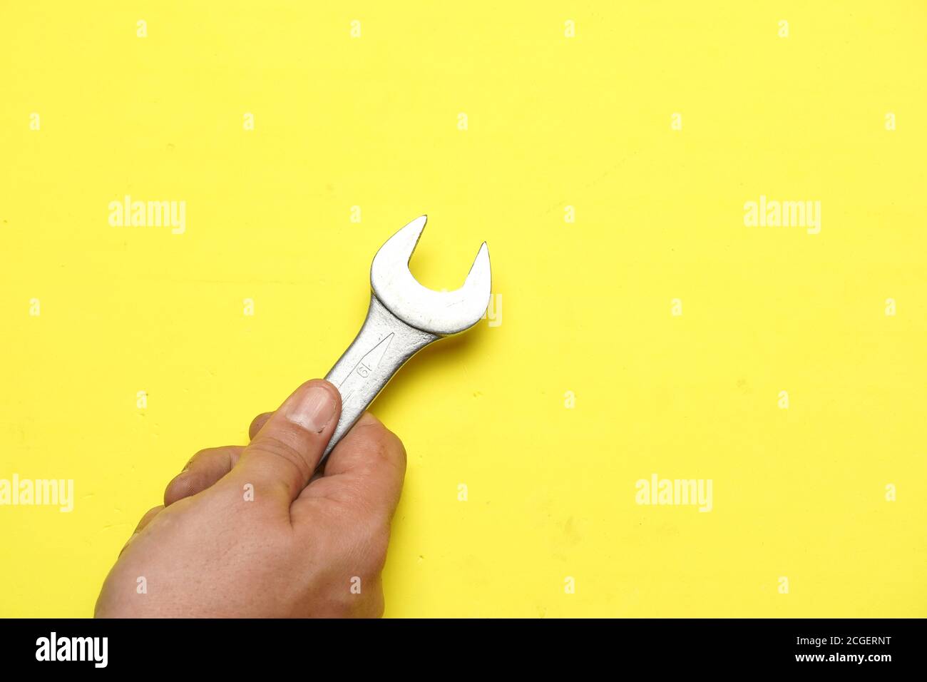 top view of man's hand grabbing a tool. repair or maintenance concept ...