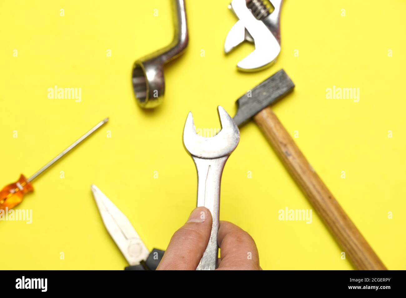 top view of man's hand grabbing a tool. repair or maintenance concept ...