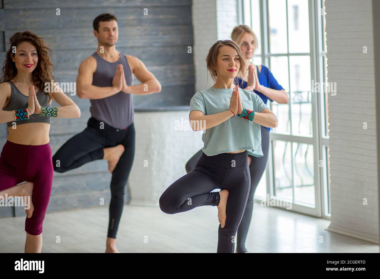 Group of people engaging in his healthy hobby-practicing yoga pose ...