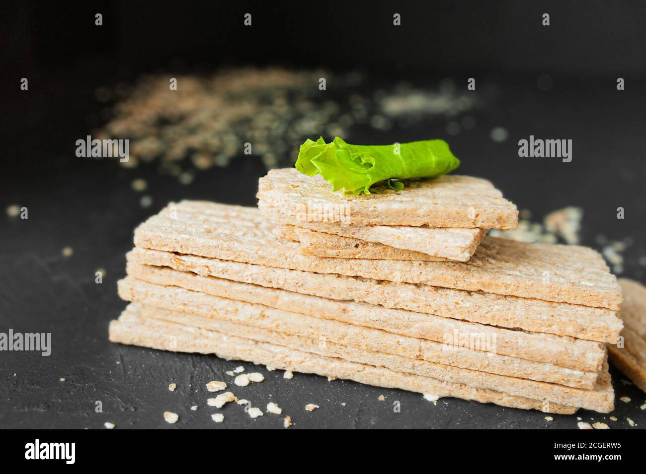 stack of healthy bread crispbread for dieting and a small leaf of fresh ...